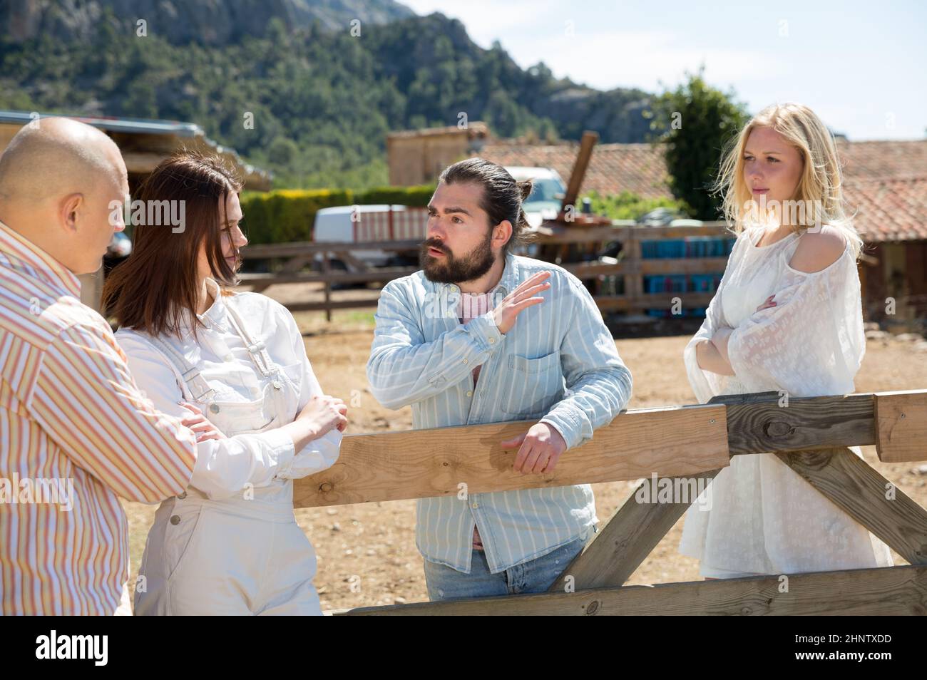 Quarrel of four friends in the country in the village Stock Photo - Alamy