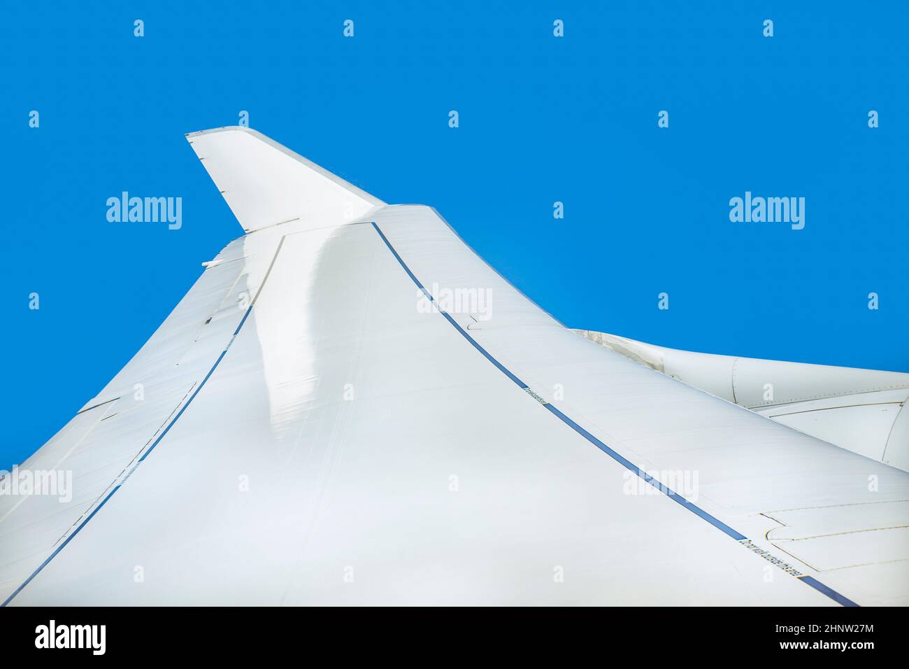 detail of aircraft wing in the air under clear blue sky Stock Photo - Alamy