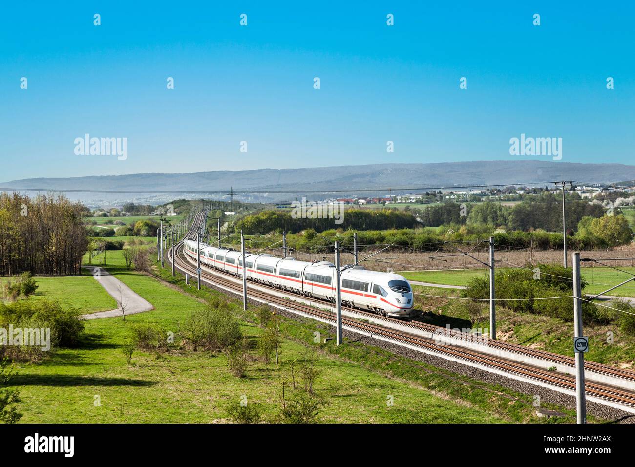 high speed train with full speed in landscape Stock Photo - Alamy