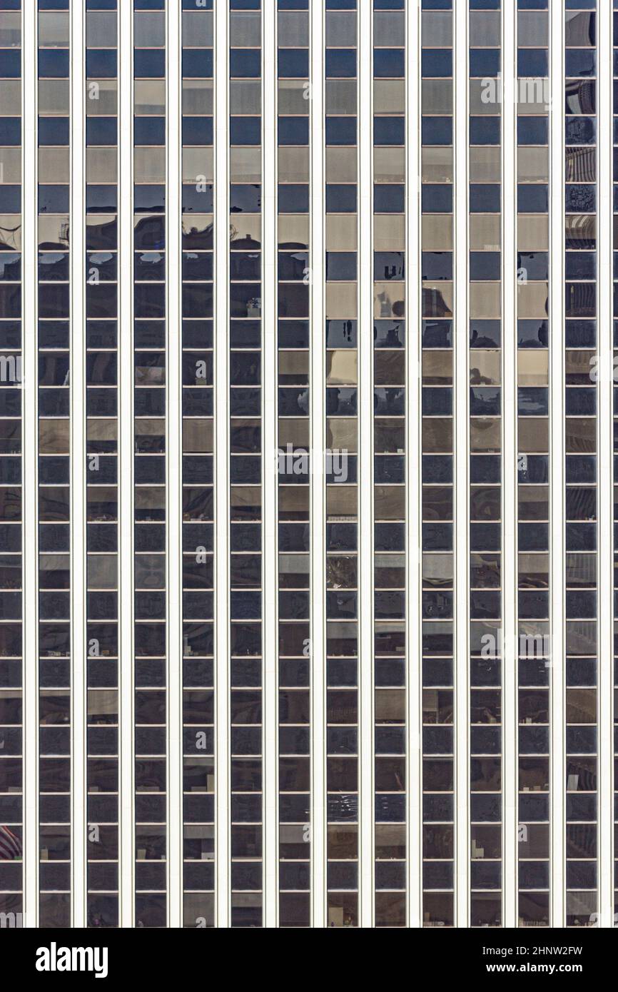 facade of futuristic skyscraper with glass windows in rectangular forms ...