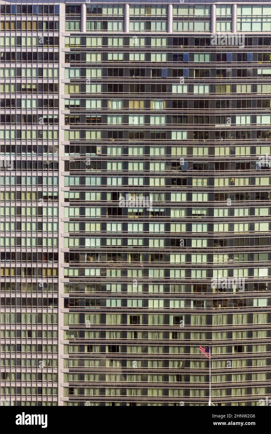 facade of futuristic skyscraper with glass windows in rectangular forms ...