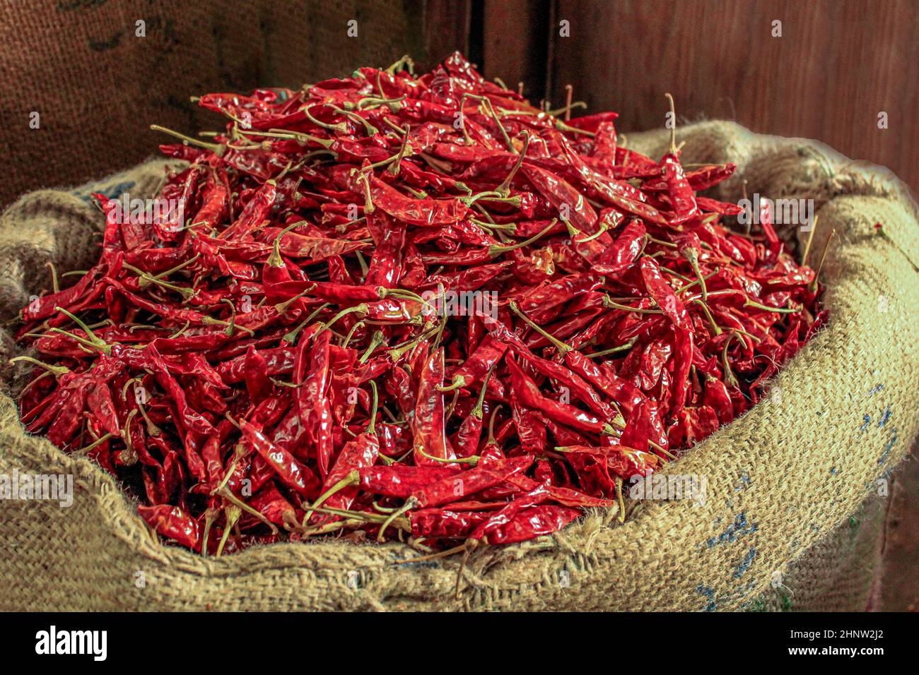 hot dried chili pepper in a sack to sell by weight Stock Photo - Alamy