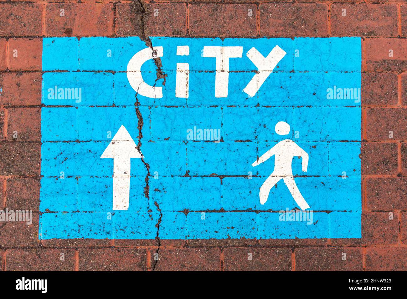 signage way to city with arrow and man in blue Stock Photo - Alamy