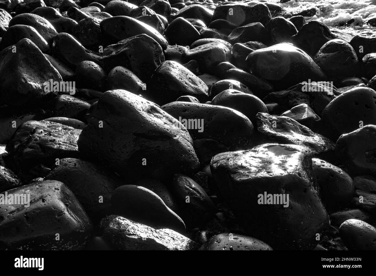 pebble stone beach in morning light with harmonic reflections Stock ...