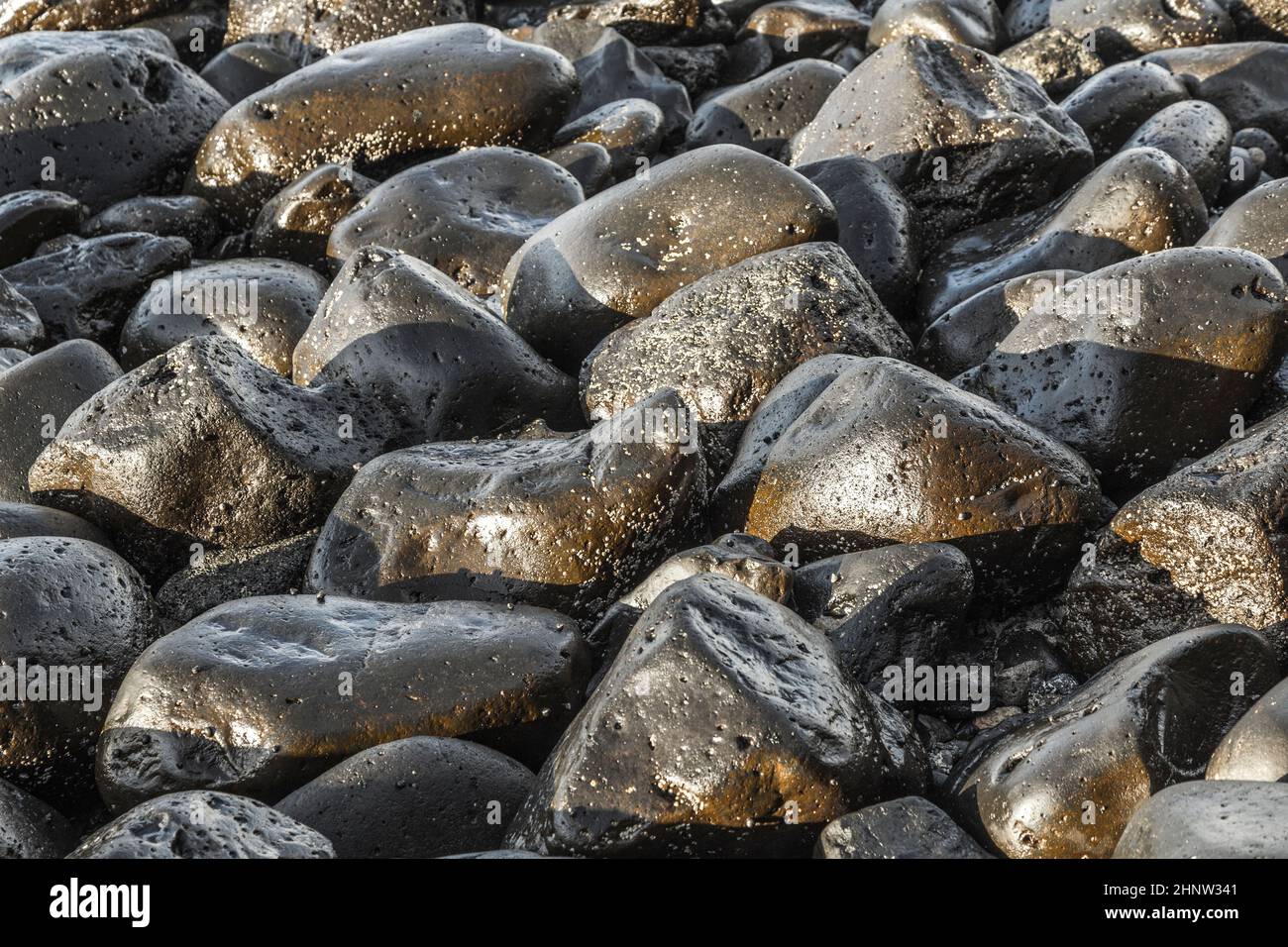 pebble stone beach in morning light with harmonic reflections Stock ...