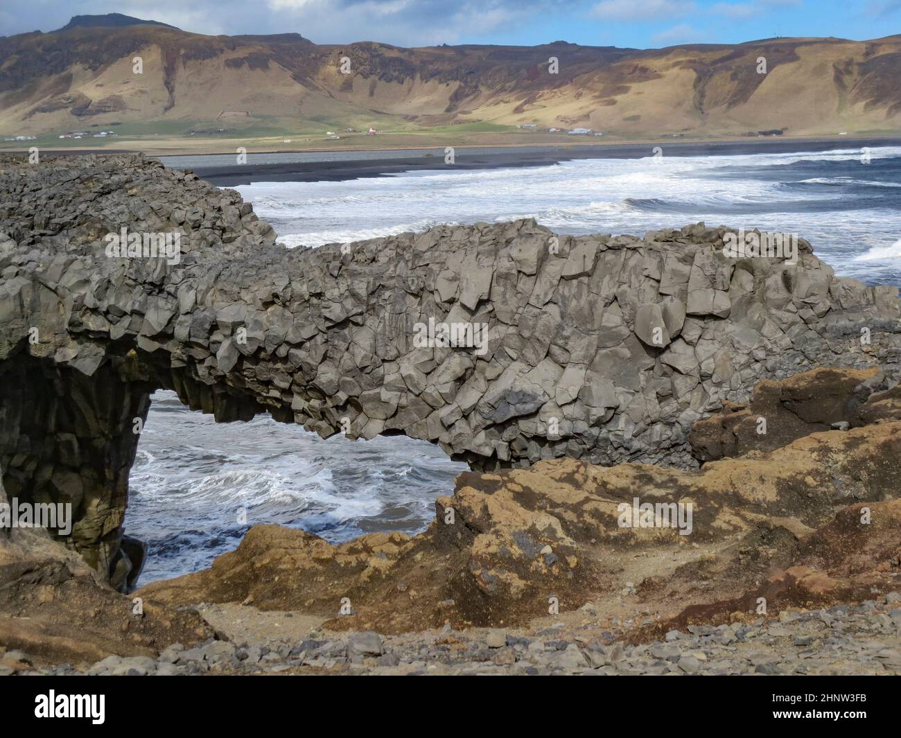 famous black basalt rock bridge in iceland. hexagon stone bridge in vik ...