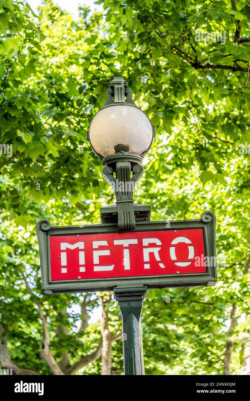 Metro sign in Paris with trees in background Stock Photo - Alamy