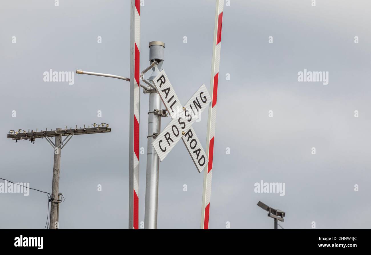 railroad crossing sign in america under cloudy sky Stock Photo - Alamy