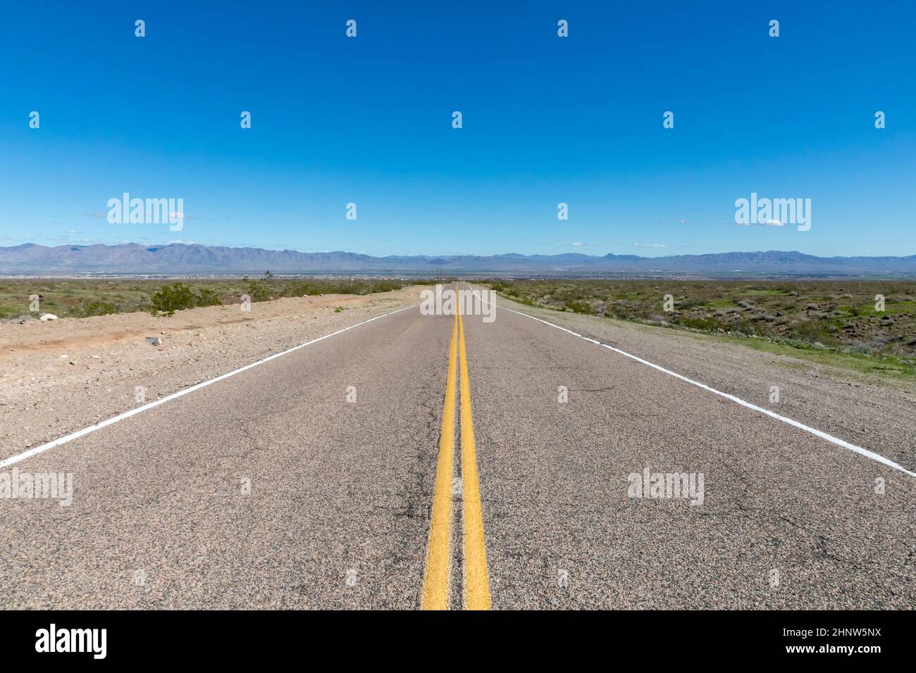 freeway in the Mohave valley in Arizona, USA with mountains at horizon ...