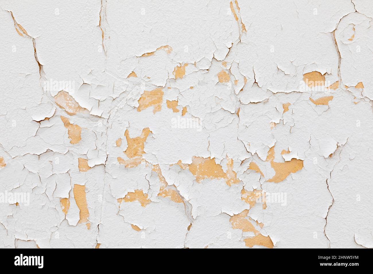 white old paint is peeling of a wall and gives an harmonic symbol for ...