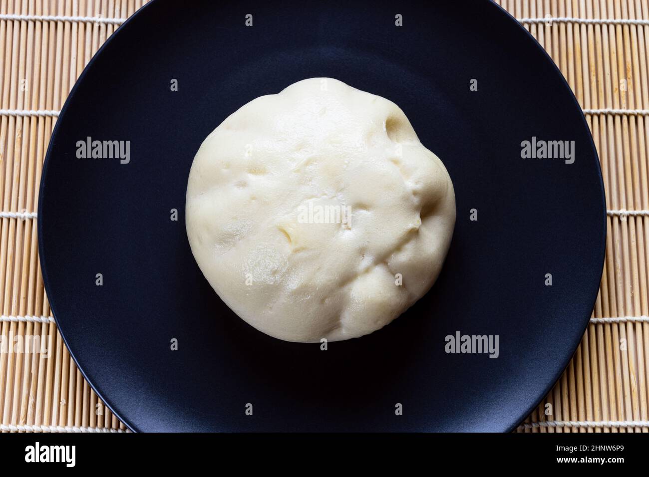 top view of steamed Banh bao, Vietnamese savory filled bun, on black ...