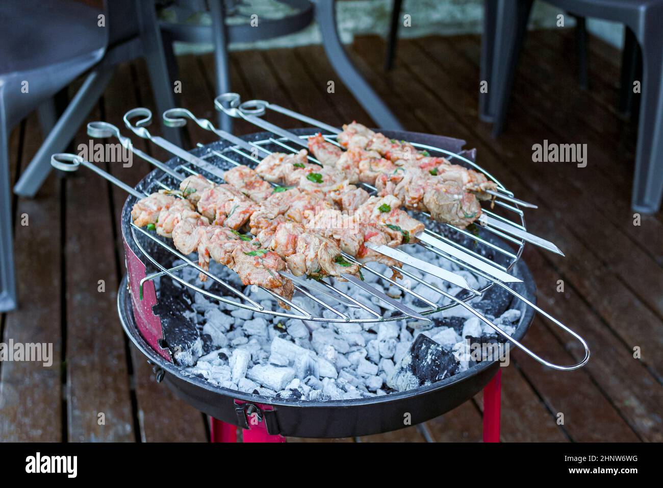 Russian shashlik with skewers on a round grill in Norway Stock Photo ...