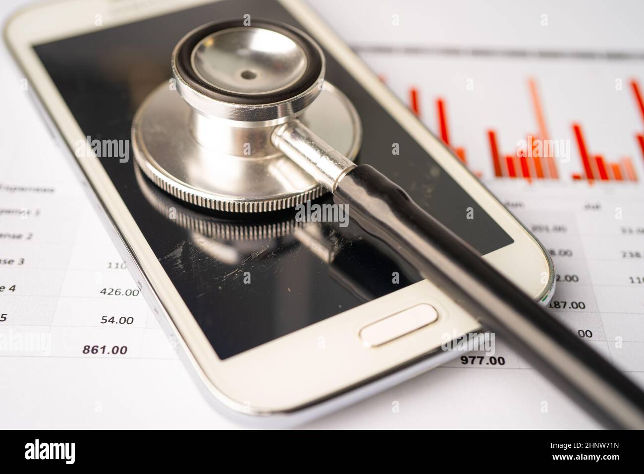 Stethoscope with mobile phone on graph paper, Finance, Account ...