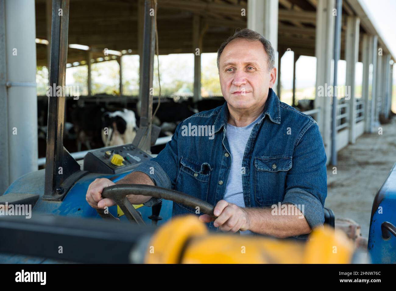 Elderly farmer driving tractor hi-res stock photography and images - Alamy