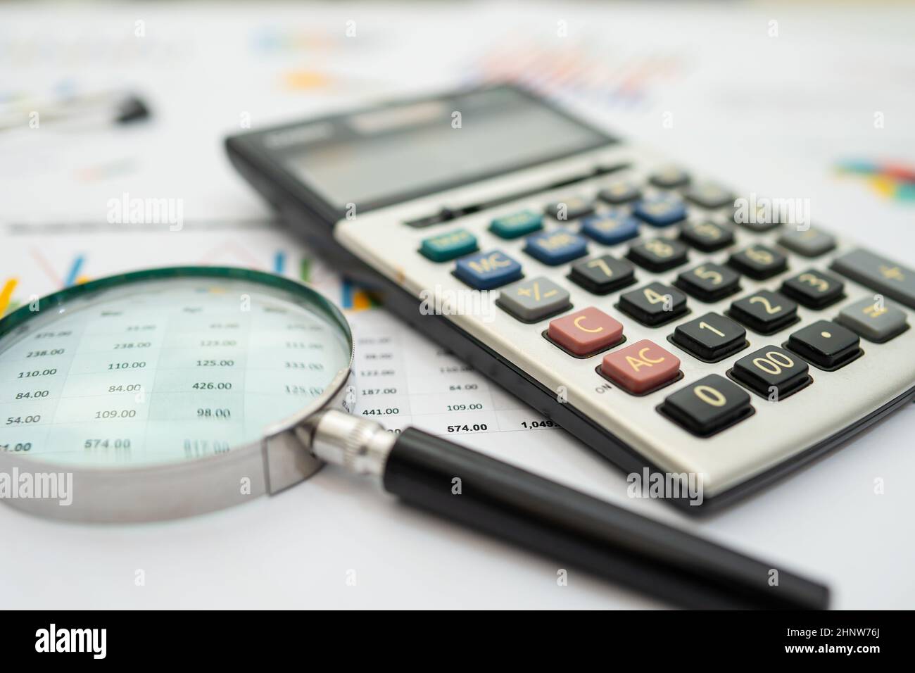 Calculator on chart and graph spreadsheet paper. Finance development ...