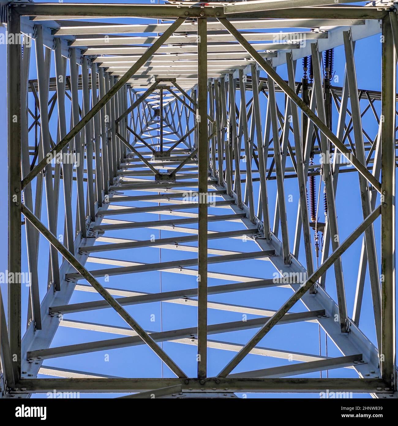 gray electric pylon under clear blue sky Stock Photo - Alamy