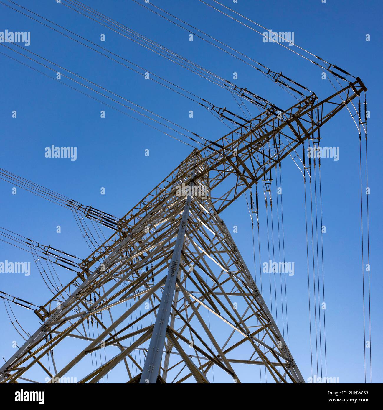 electric pylon at a power station under blue sky in Germany Stock Photo ...