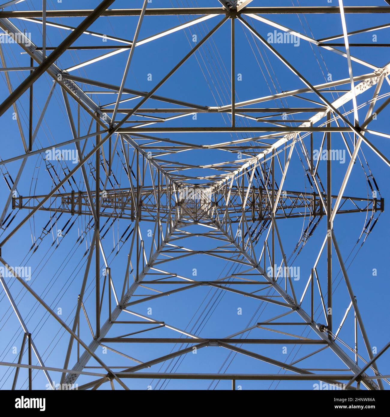 electric pylon at a power station under blue sky in Germany Stock Photo ...