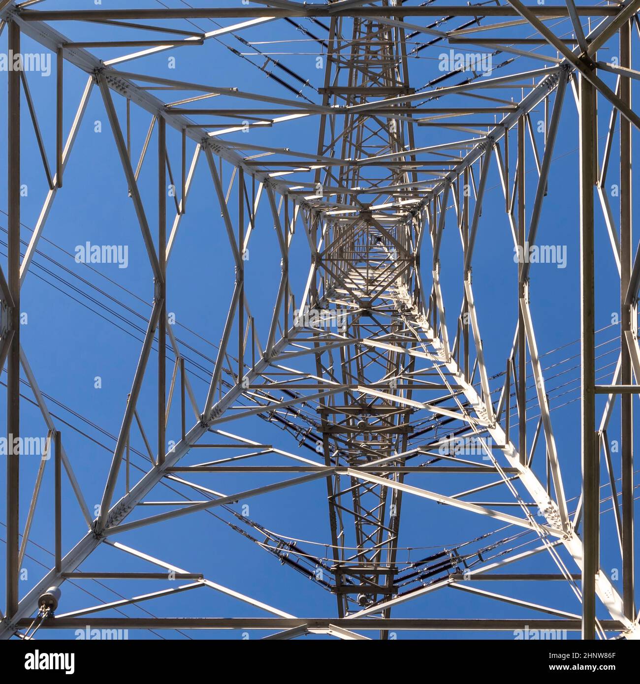 electric pylon at a power station under blue sky in Germany Stock Photo ...