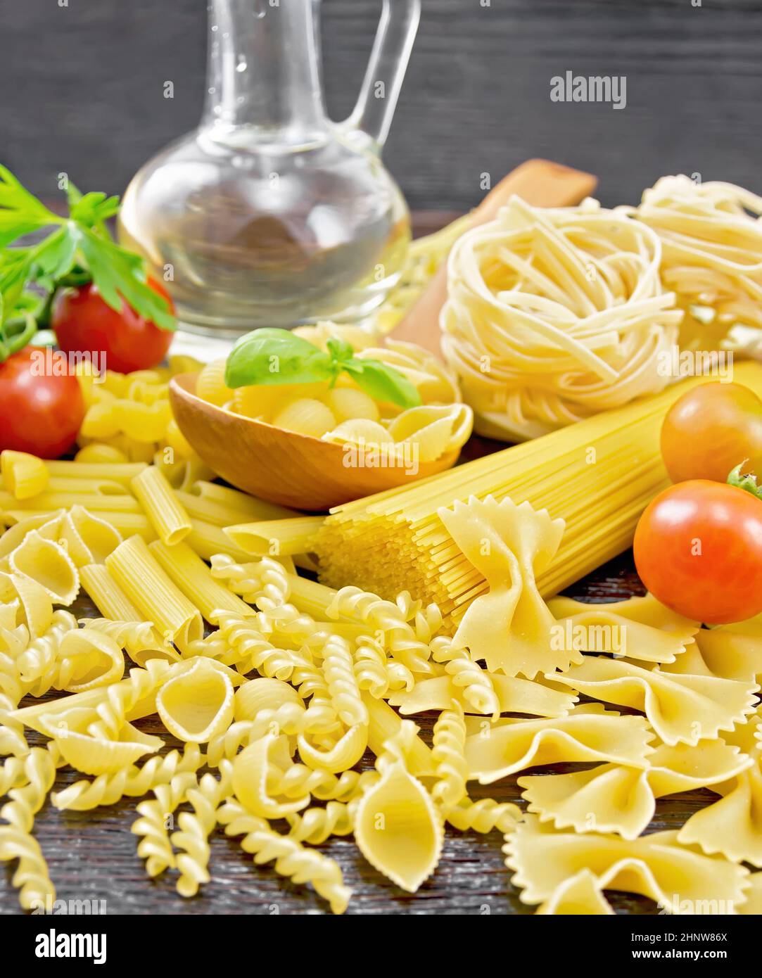 Pasta seashells in spoon, pipe rigate, spaghetti, tagliatelle, fusilli ...