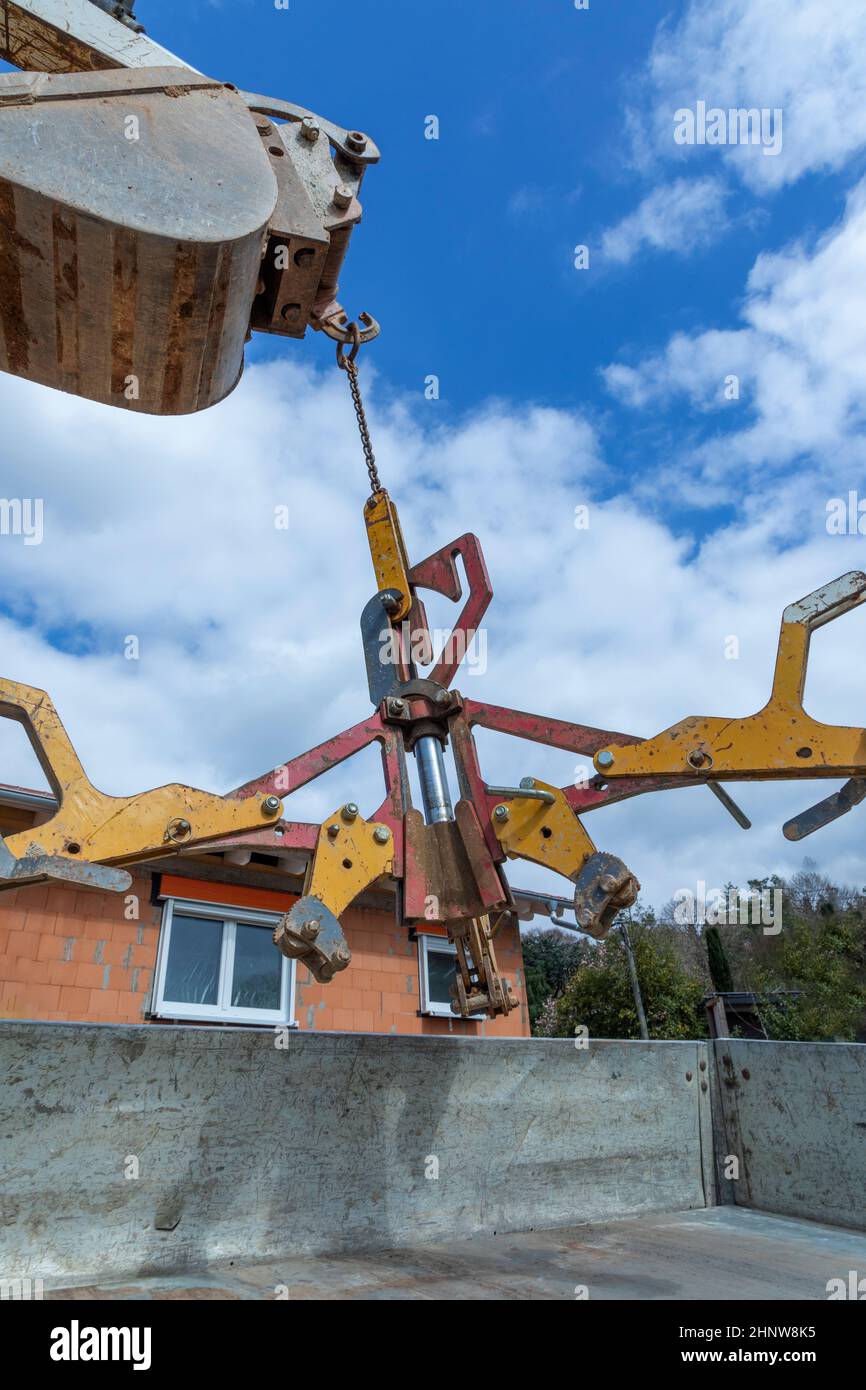 lifting claw at a crane is removed to trailer Stock Photo - Alamy