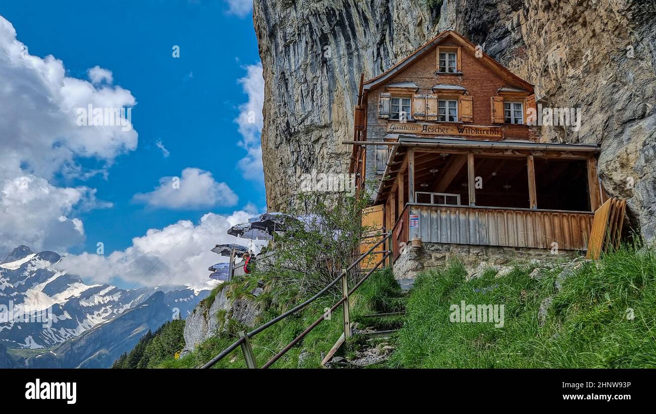 Low angle shot of Ebenalp with its famous cliff inn Aescher ...