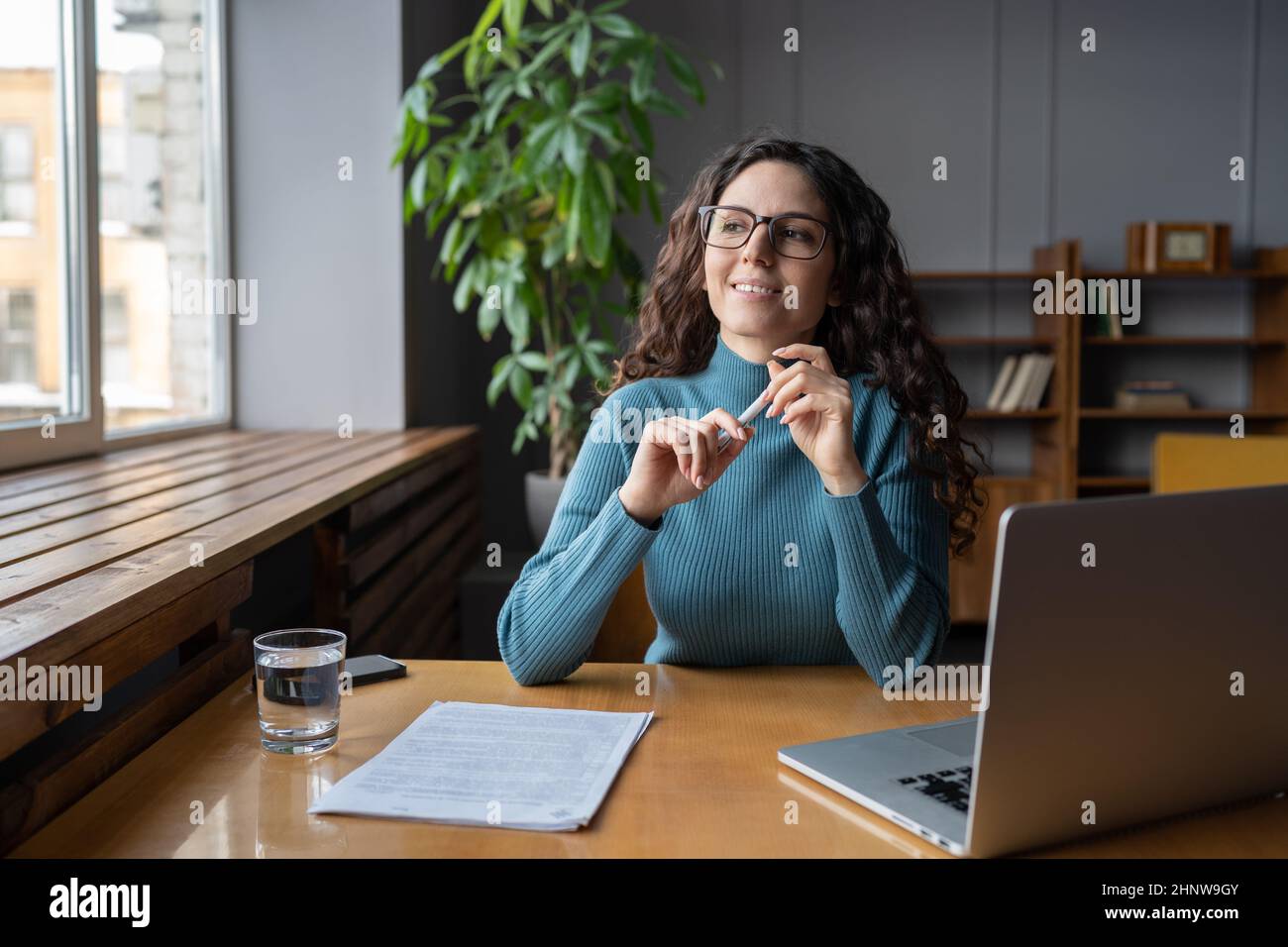 Employee wellbeing. Happy female office worker resting at workplace ...