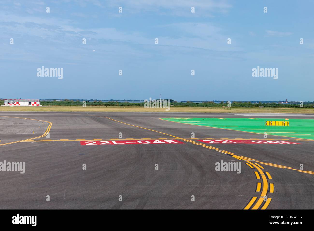 runway of airport with cloudy sky and print of wheels at the surface ...