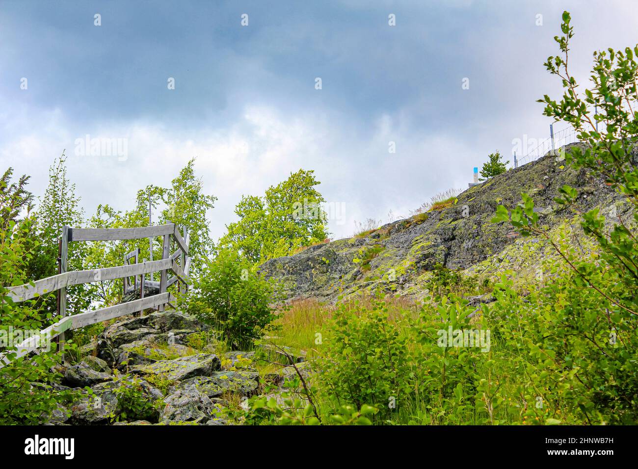 Stunning Norwegian landscape with mountains and valley behind a fence ...