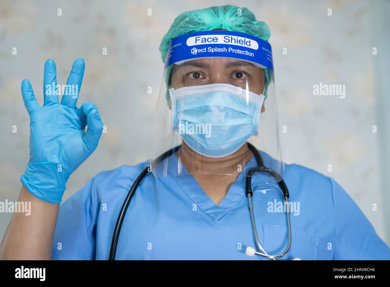 Asian doctor wearing face shield and PPE suit new normal to check ...