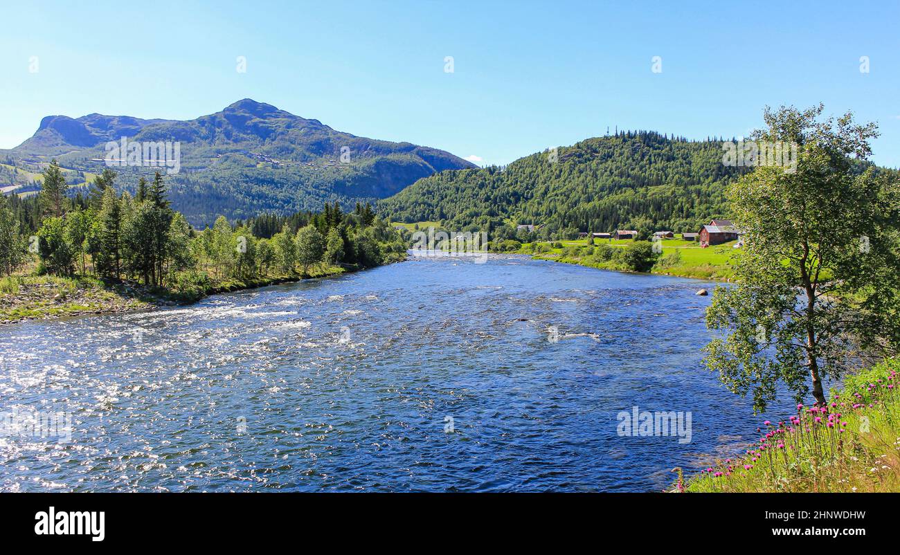 Flowing beautiful river lake Hemsila with mountain panorama in Hemsedal ...