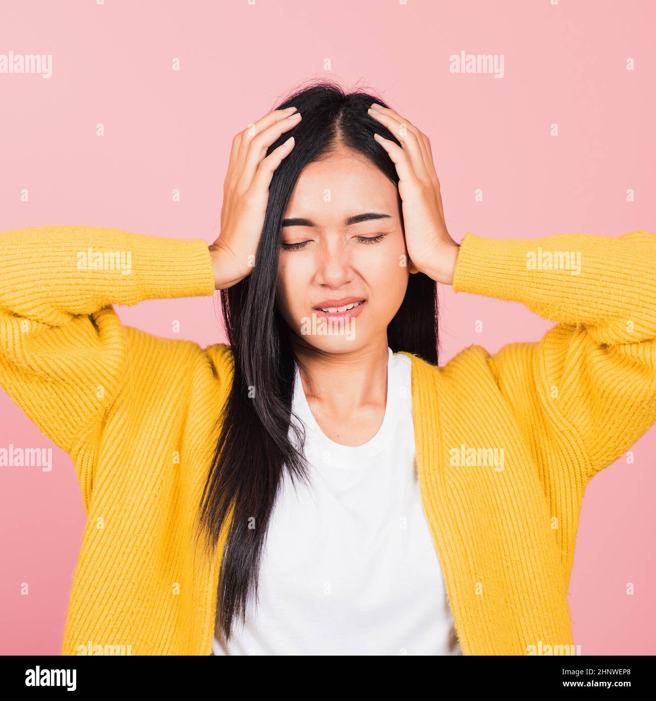 Portrait of beautiful Asian young woman sad tired strain face holding ...