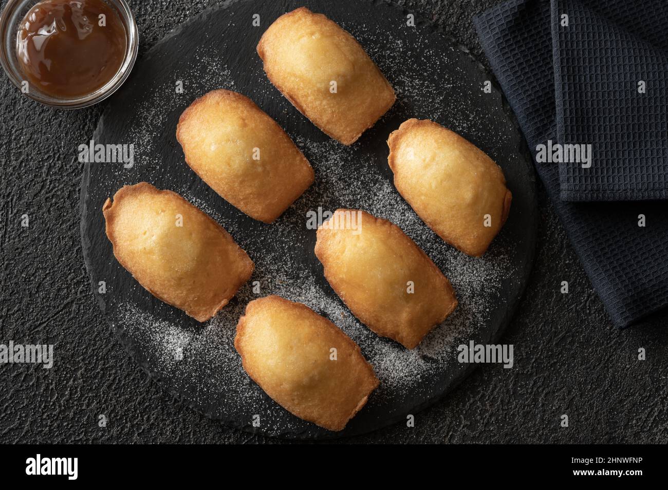 Madeleines - French small sponge cakes on the stone board Stock Photo ...