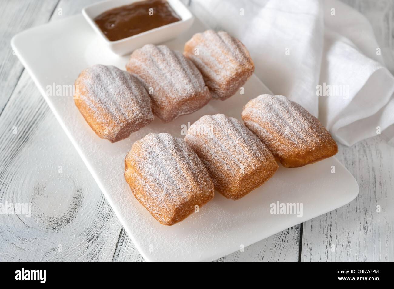 Madeleines - French small sponge cakes on the serving plate Stock Photo ...