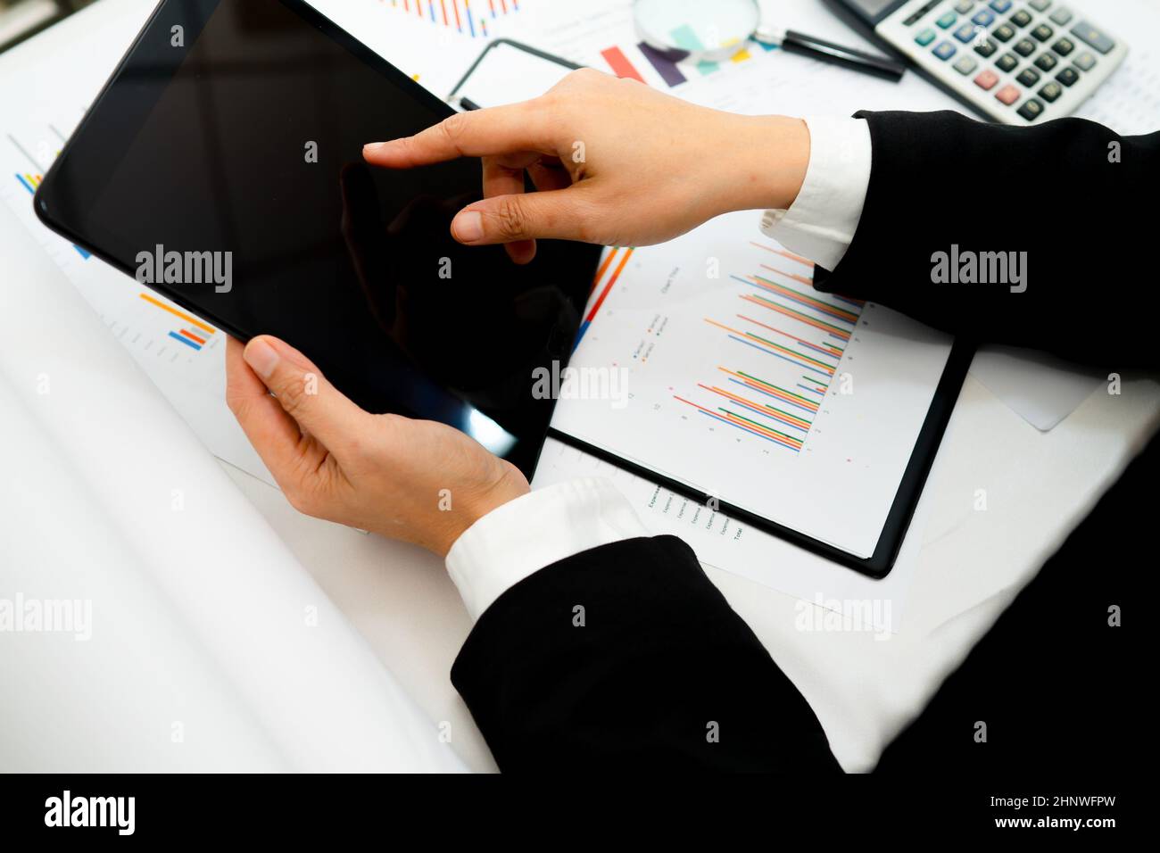 Asian accountant working and analyzing financial reports project ...