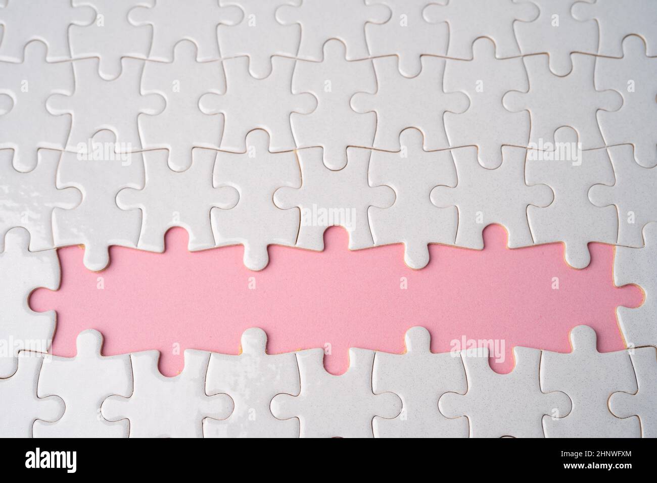 Jigsaw puzzle on pink background, business teamwork, problem solving ...