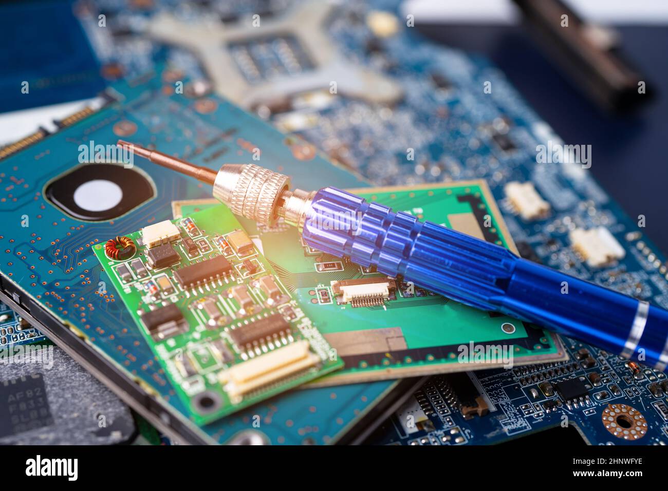 Screwdriver on the computer main board hardware. Repair upgrade and ...