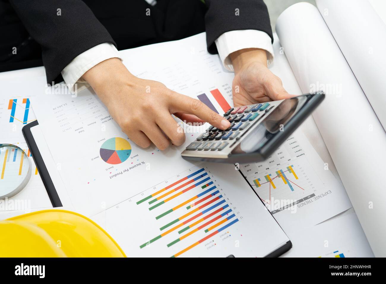 Architect or engineer working project accounting with graph and ...