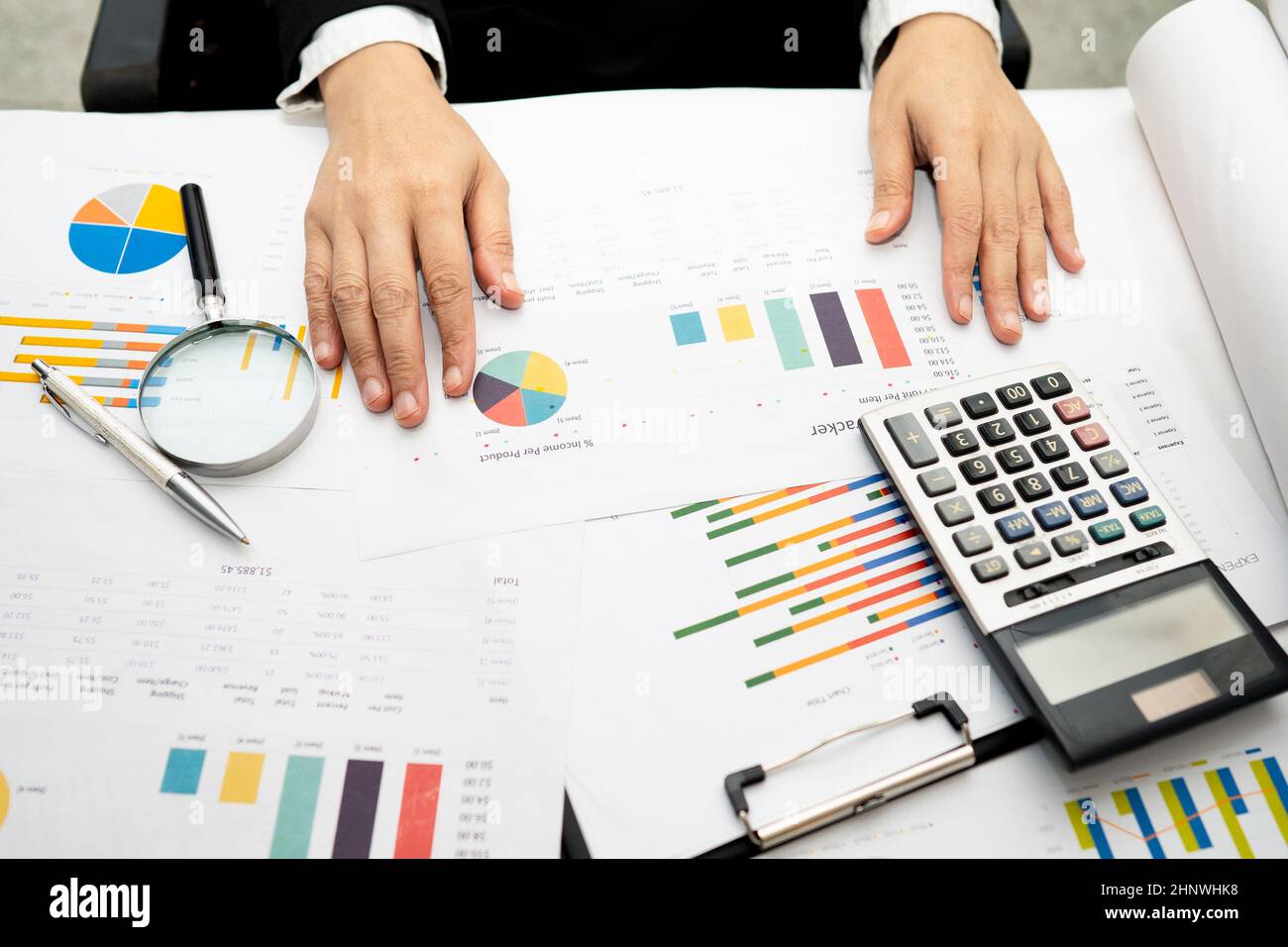 Asian accountant working and analyzing financial reports project ...