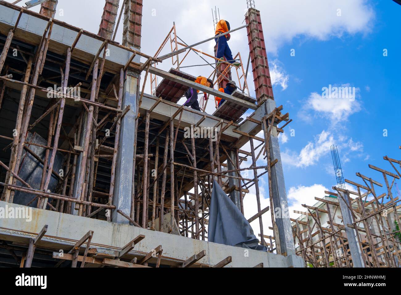 Engineer and workers in construction team building at site Stock Photo ...