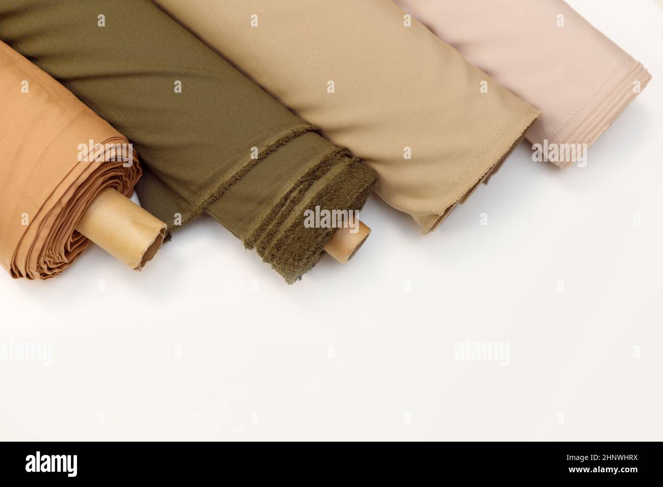 Rolls of fabric and textiles in a factory shop or store or bazar. Multi ...