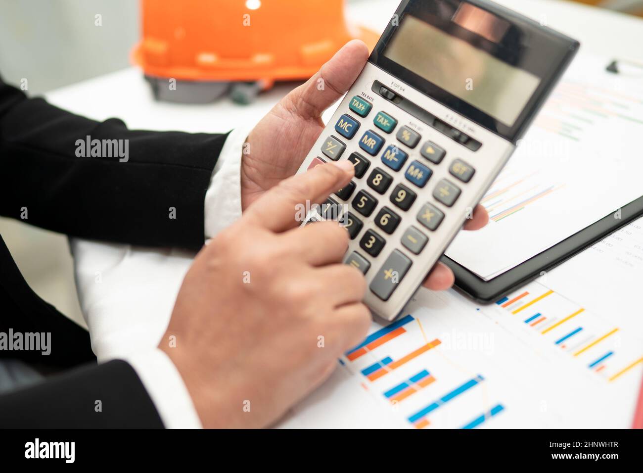 Architect or engineer working project accounting with graph and ...