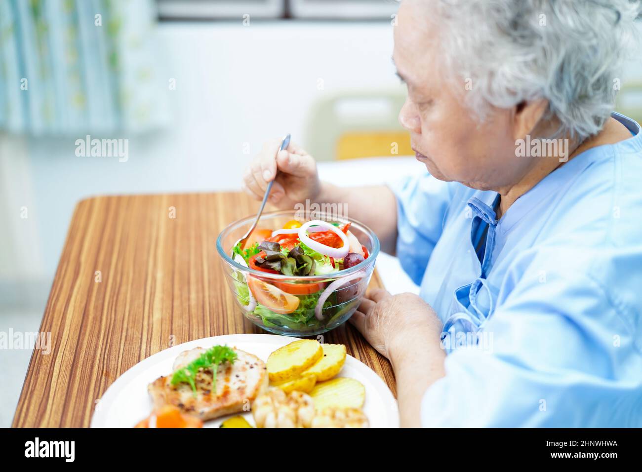 Asian senior or elderly old lady woman patient eating breakfast ...