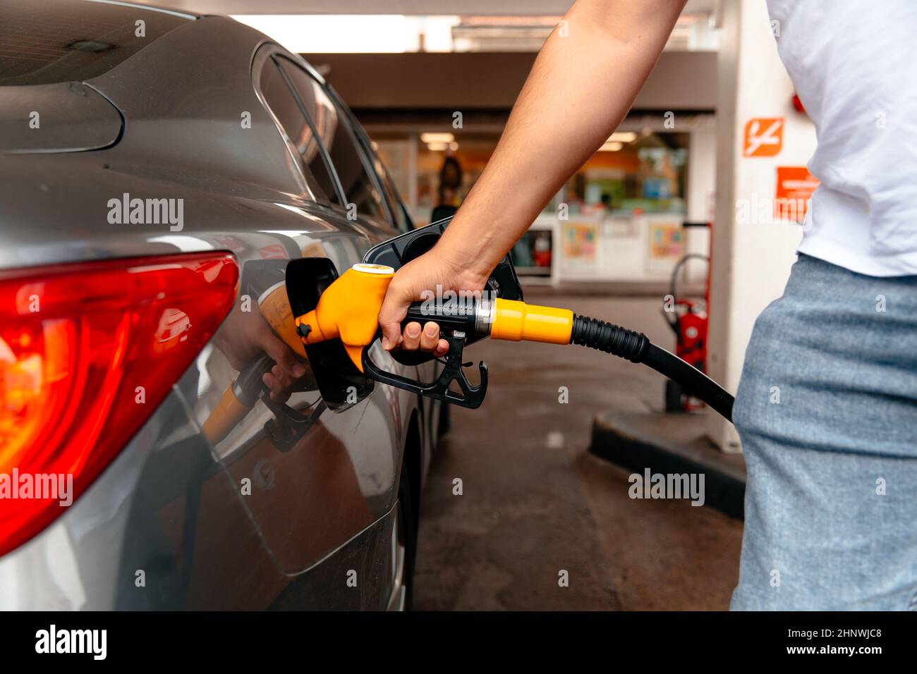 Young man, fill diesel tank of car after finish refill diesel oil and ...