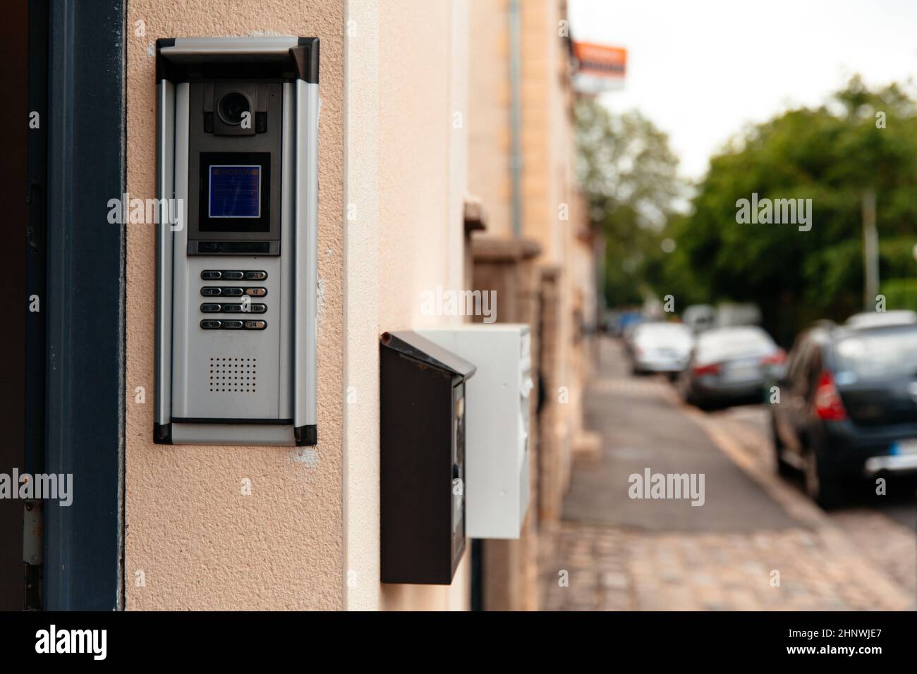 Silver intercom call panel and a video camera in the entry of a private ...