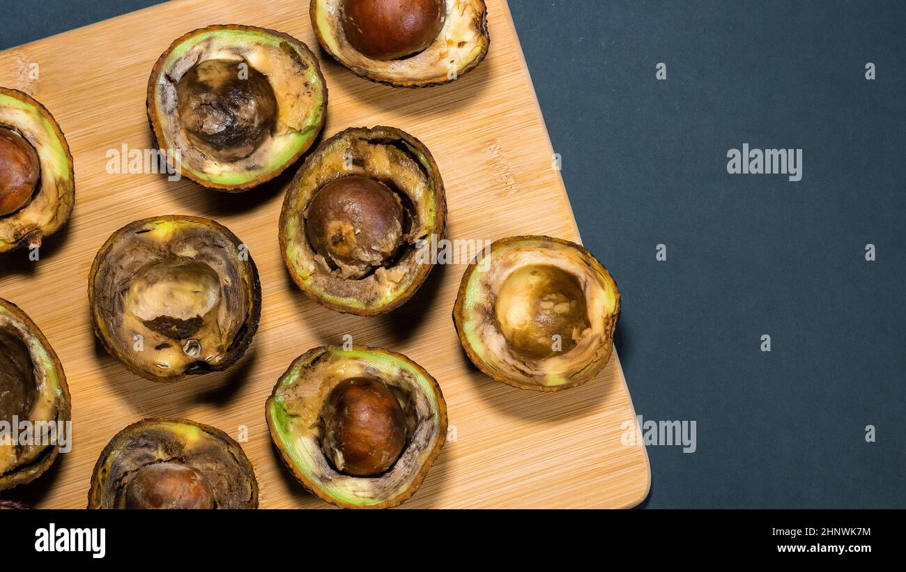 Overripe Avocado on wood Chipper dark background. Rotten Avocado Fruits ...