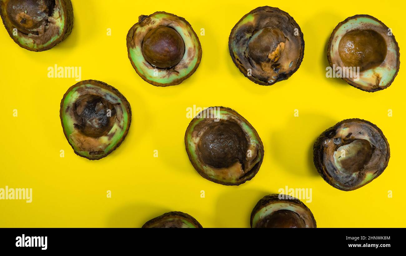 Bad Avocado halves close up on Yellow Background. Food Fruits cannot be ...