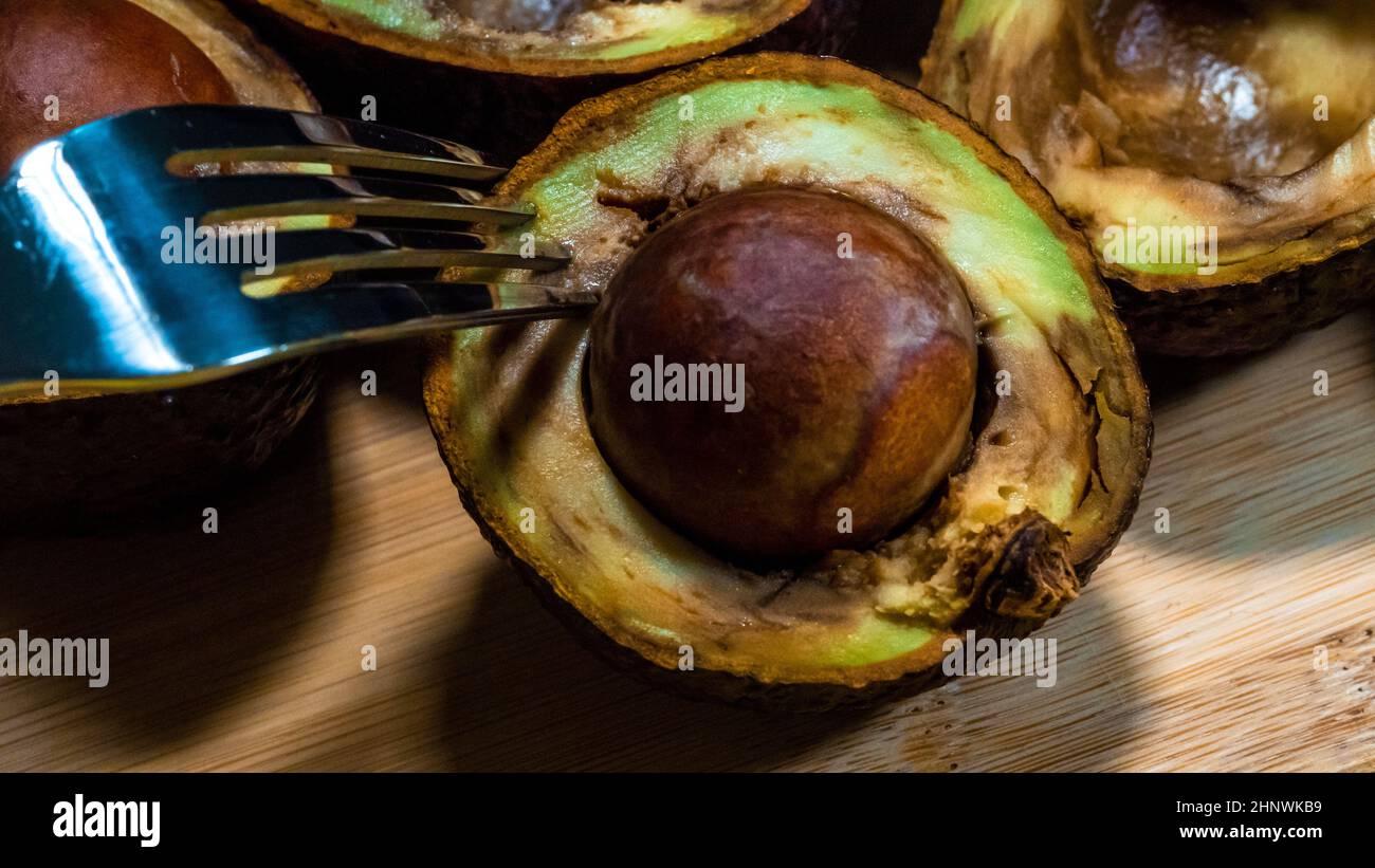 Close up Bad Avocado. Ugly Tropical fruits. Contaminated Avocado halfs ...