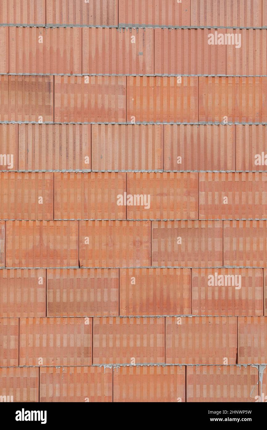 solid red brick wall of a house under construction as background Stock ...