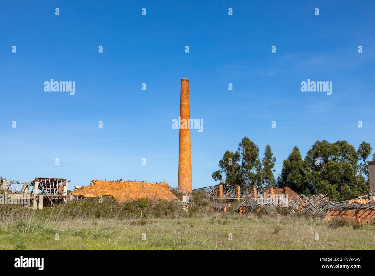 old rotten factory with damaged roof and old brick chimney in Sines ...